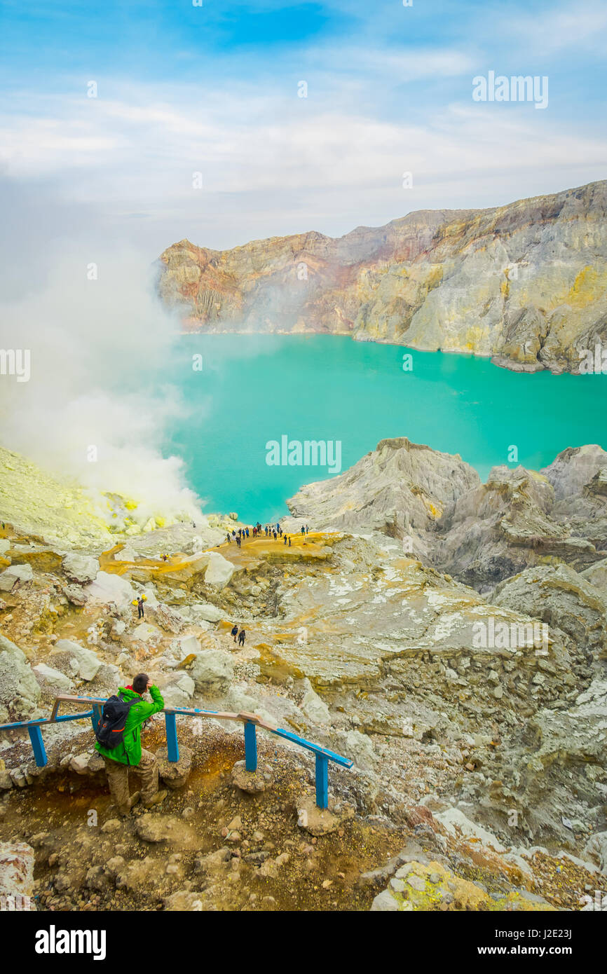 KAWEH IJEN, INDONESIA - 3 MARCH, 2017: Tourist standing on overlook ...