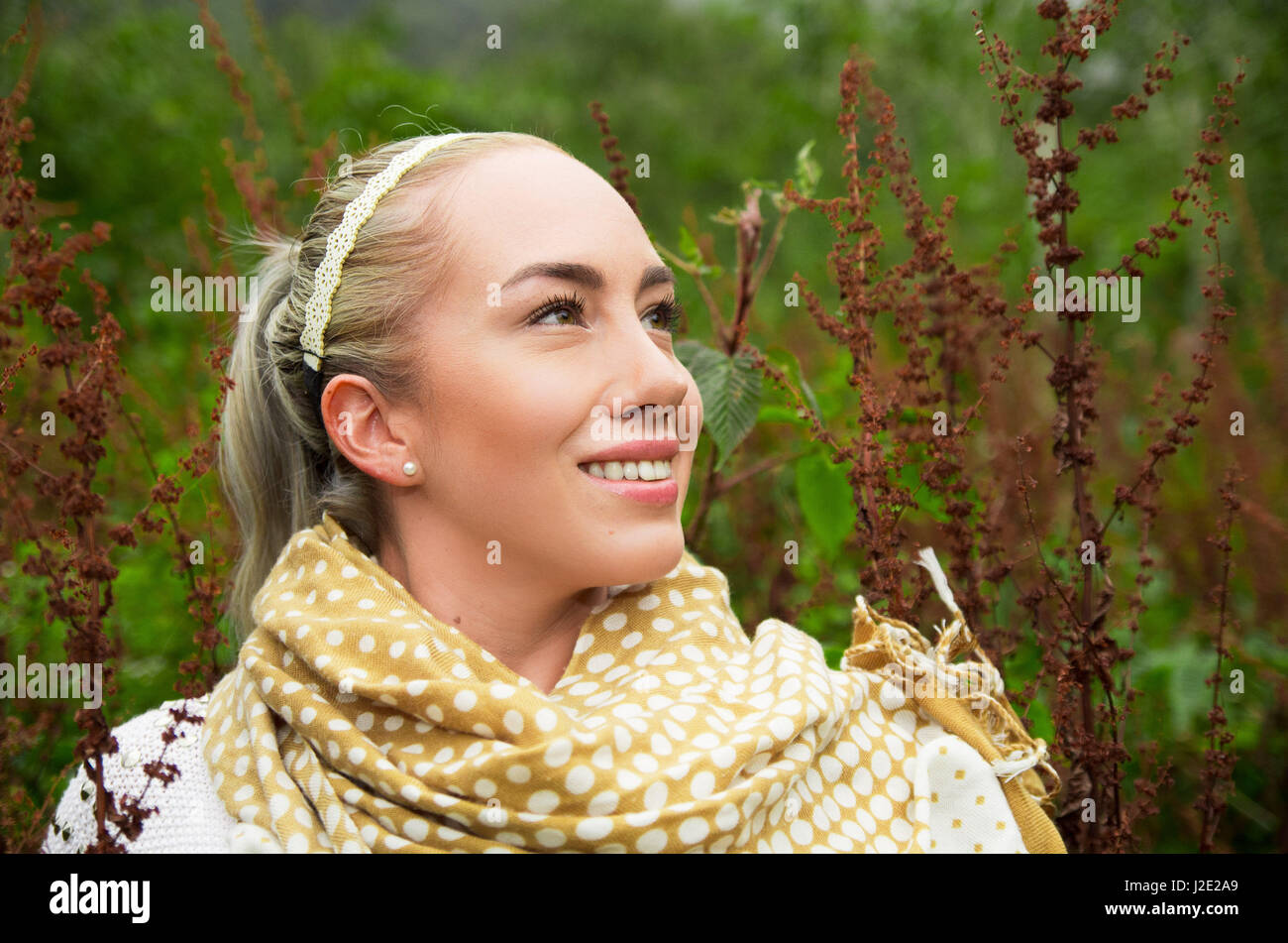 Smiling beautiful woman enjoying nature in a forest Stock Photo - Alamy