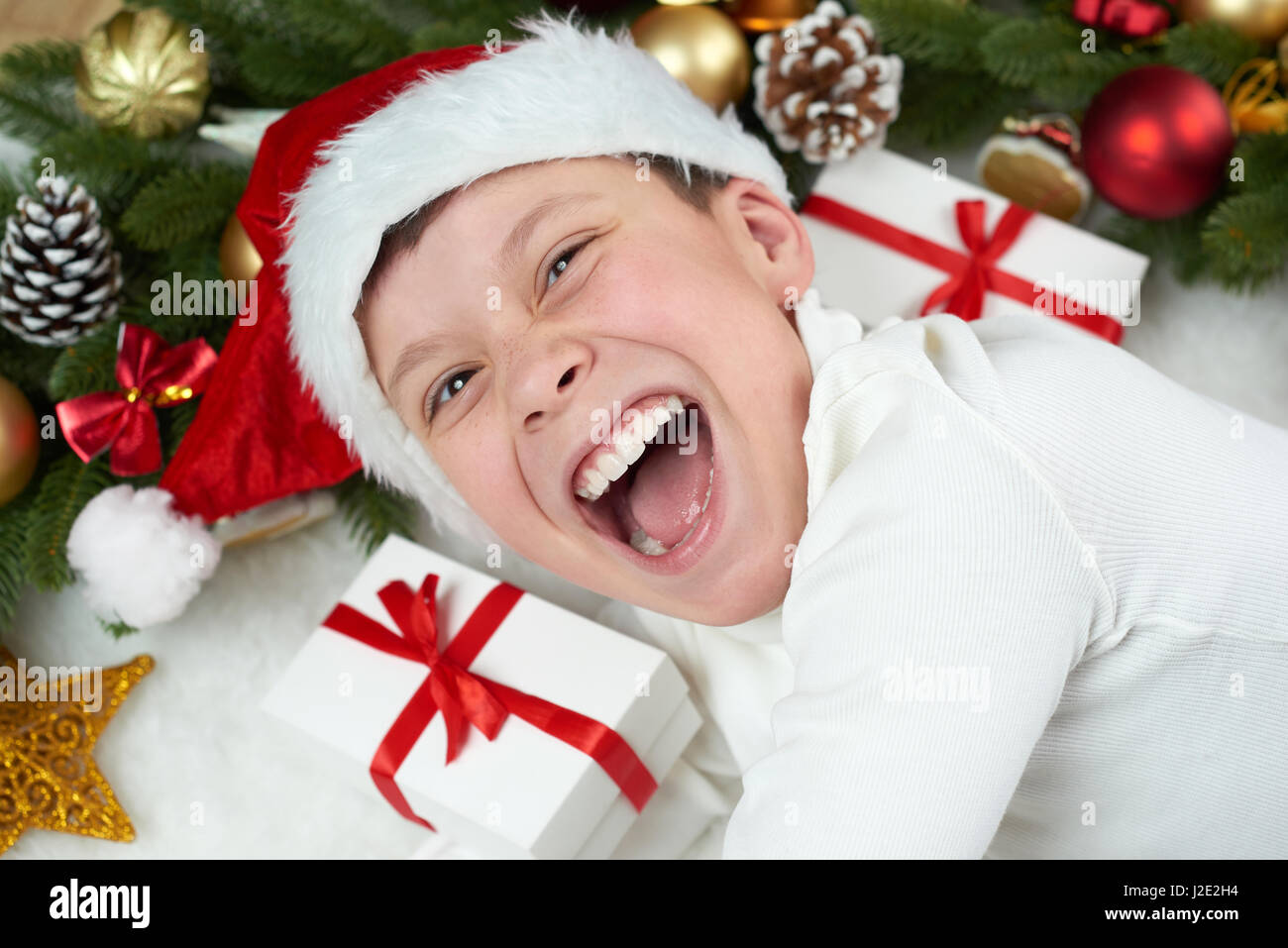 boy child having fun with christmas decoration, face expression and ...