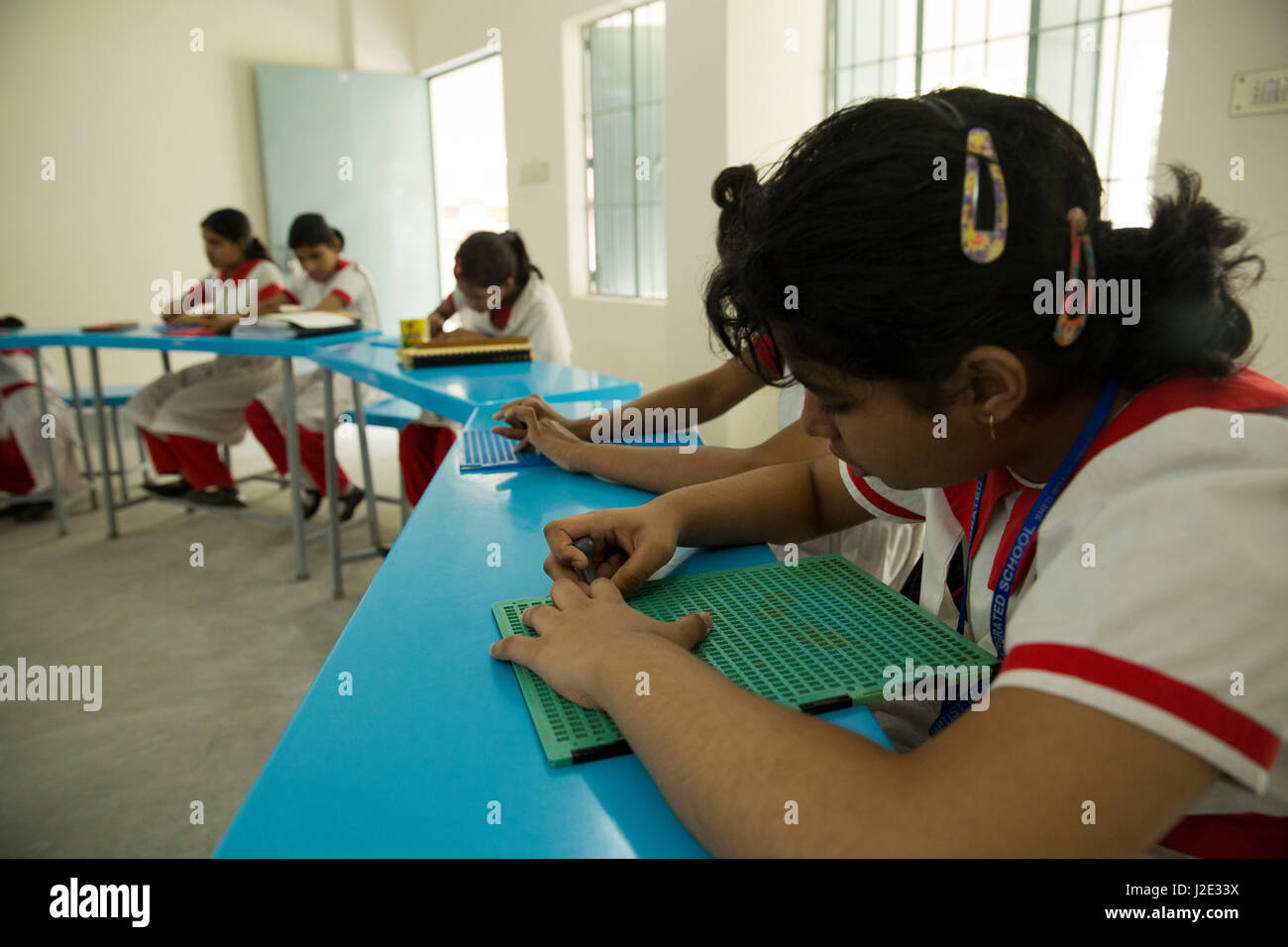 Visually impaired girl students learn in classroom with the help of ...