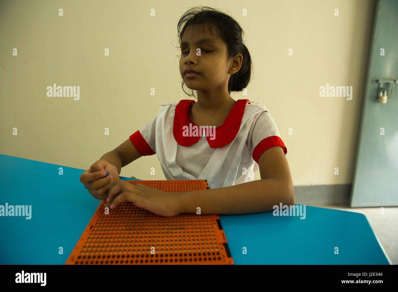 Visually impaired girl student learns in classroom with the help of ...