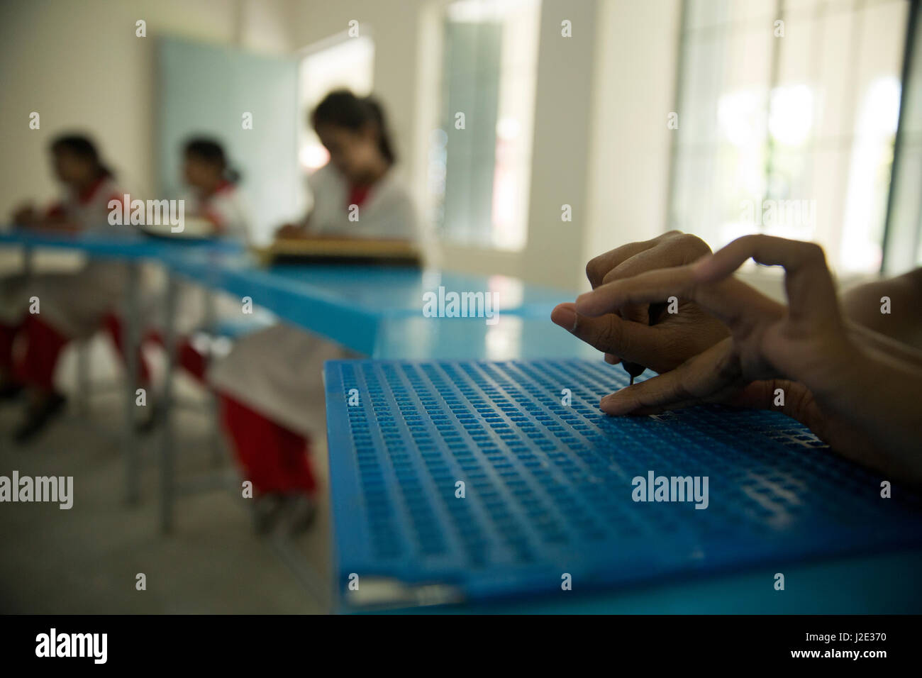 Visually impaired girl students learn in classroom with the help of ...