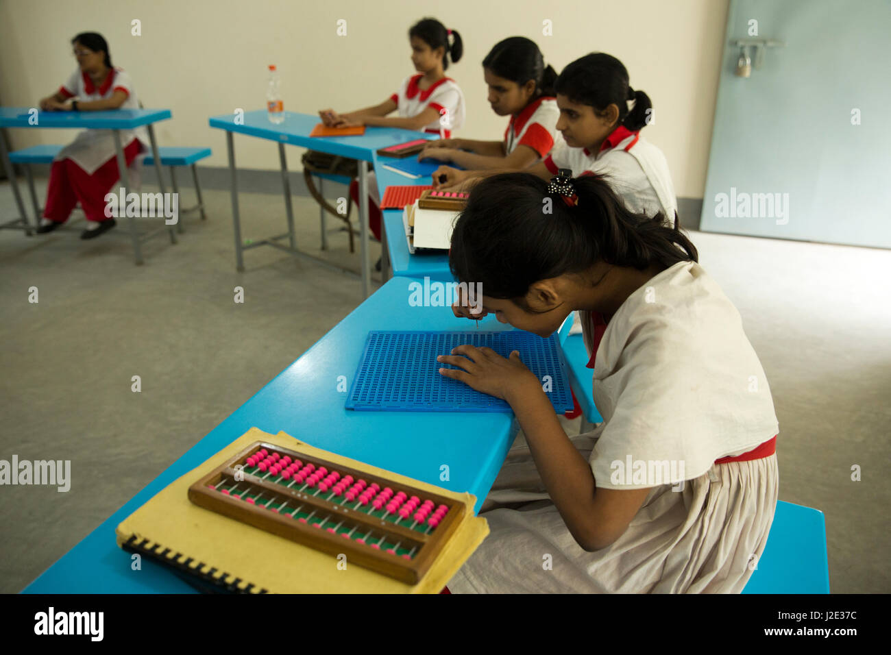 Visually impaired girl students learn in classroom with the help of ...