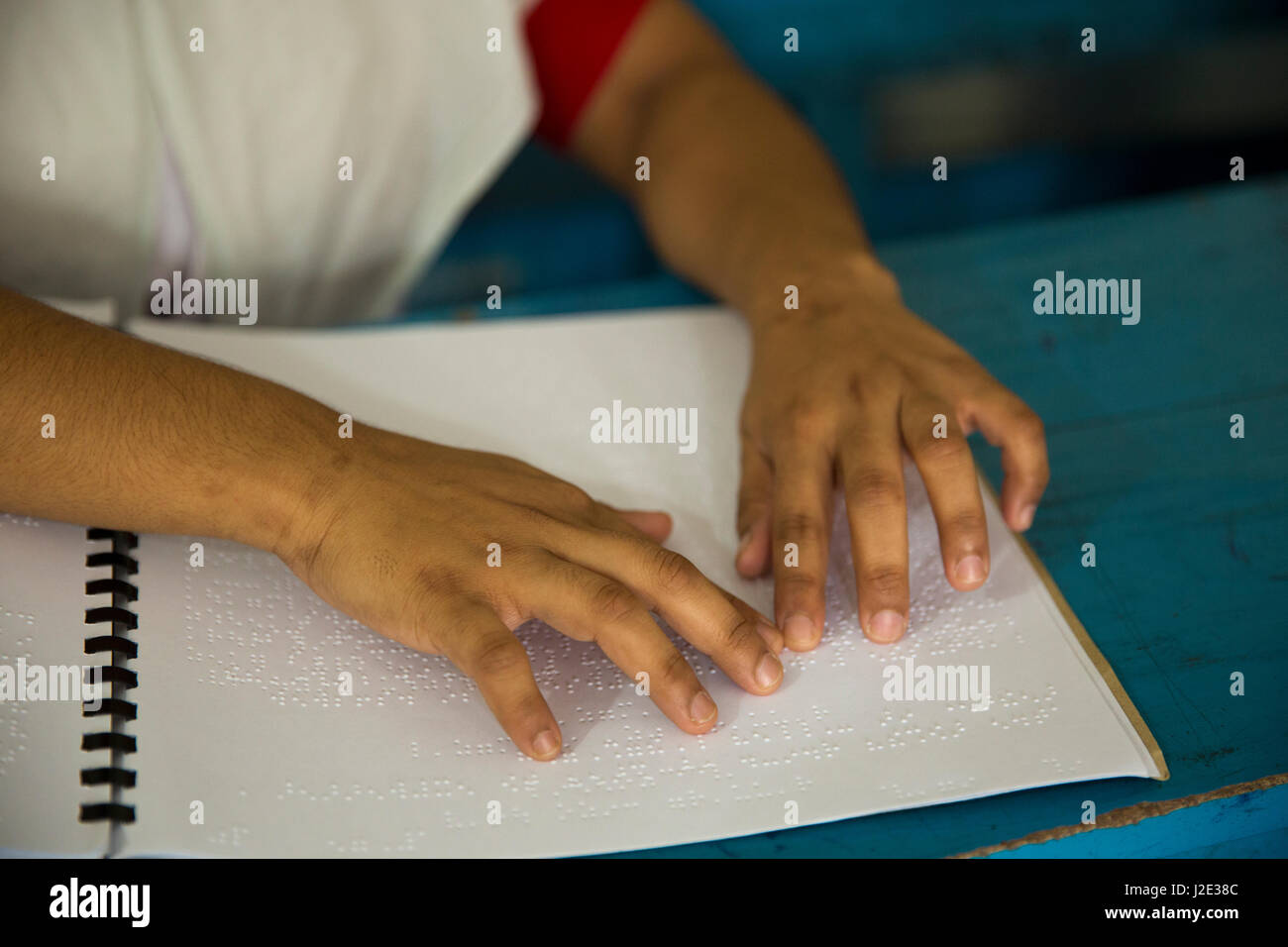 Visually impaired girl student learns in classroom with the help of ...
