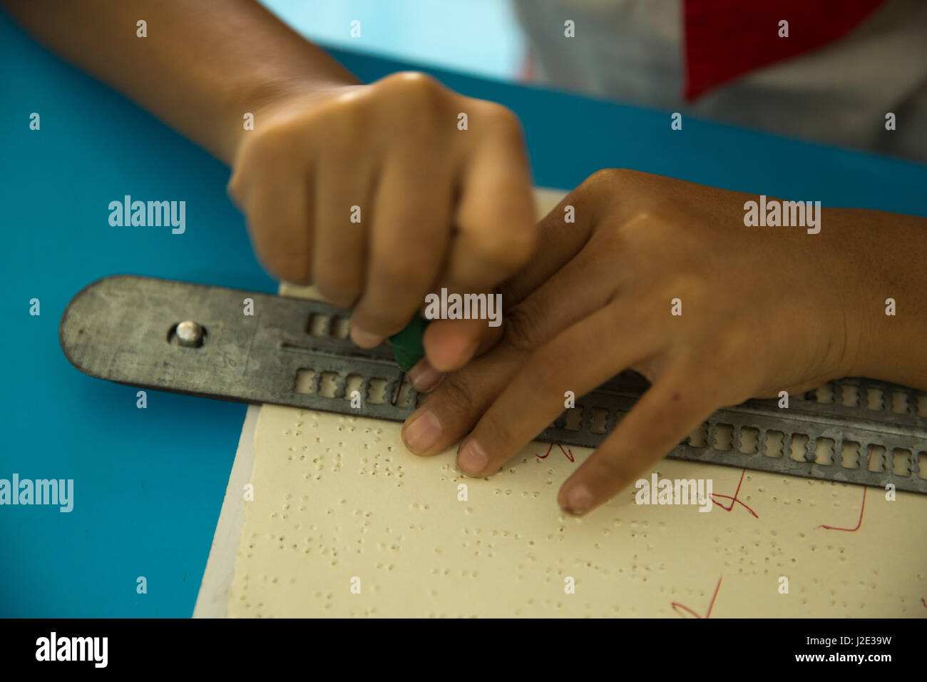Visually impaired girl student learns in classroom with the help of ...