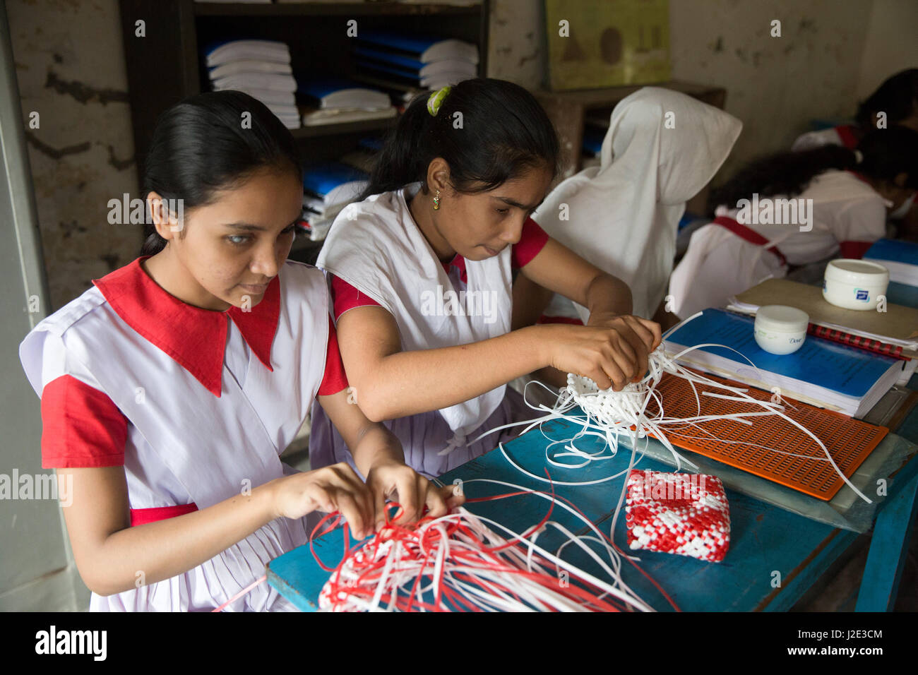 Visually impaired girl students make bags in the classroom at the ...