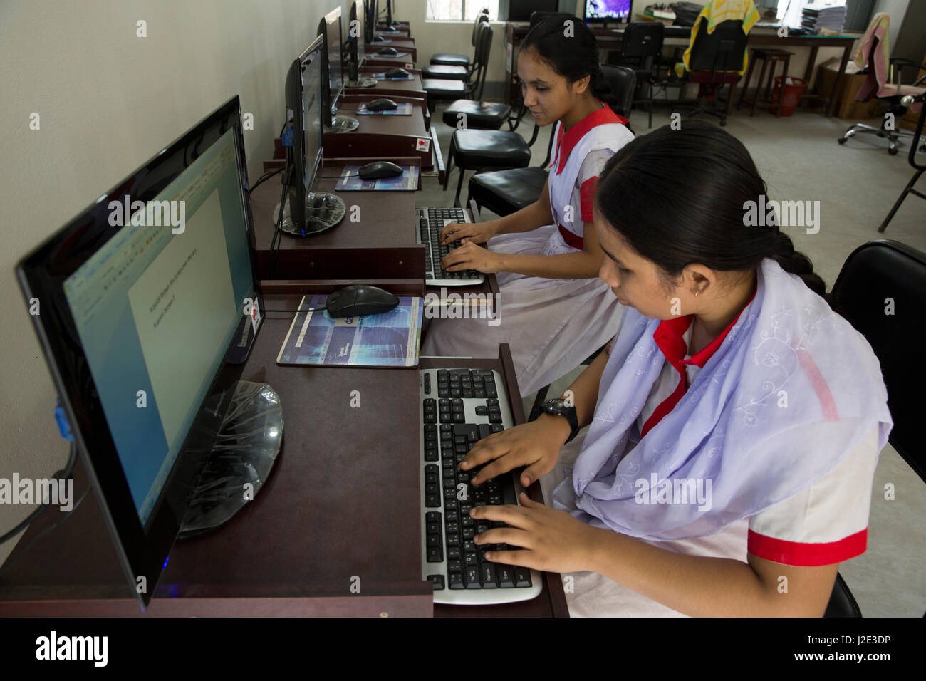 Visually impaired girl students using computer in the classroom at the ...