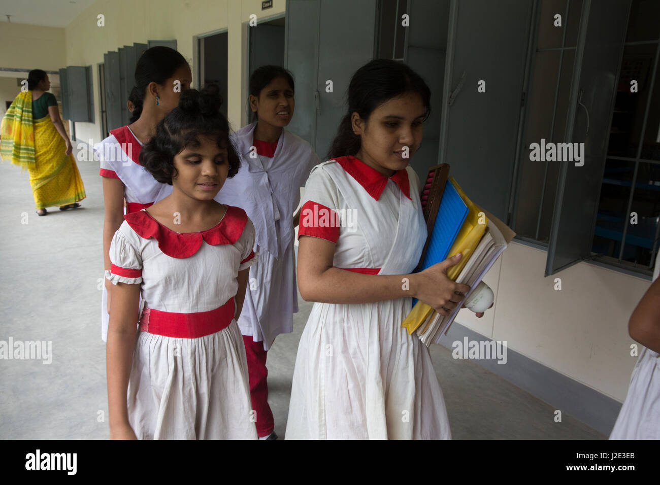 Visually impaired girl students walk through the school veranda at the ...