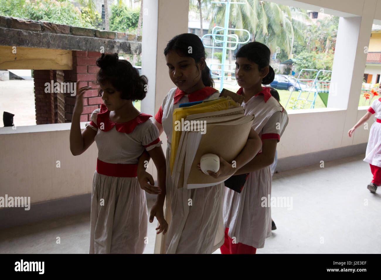 Visually impaired girl students walk through the school veranda at the ...