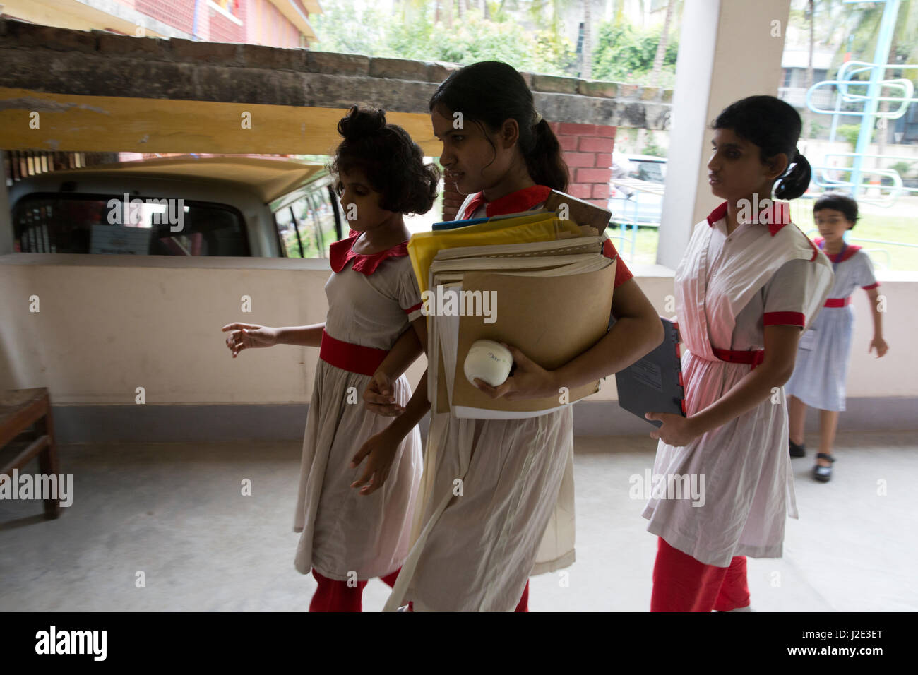 Visually impaired girl students walk through the school veranda at the ...