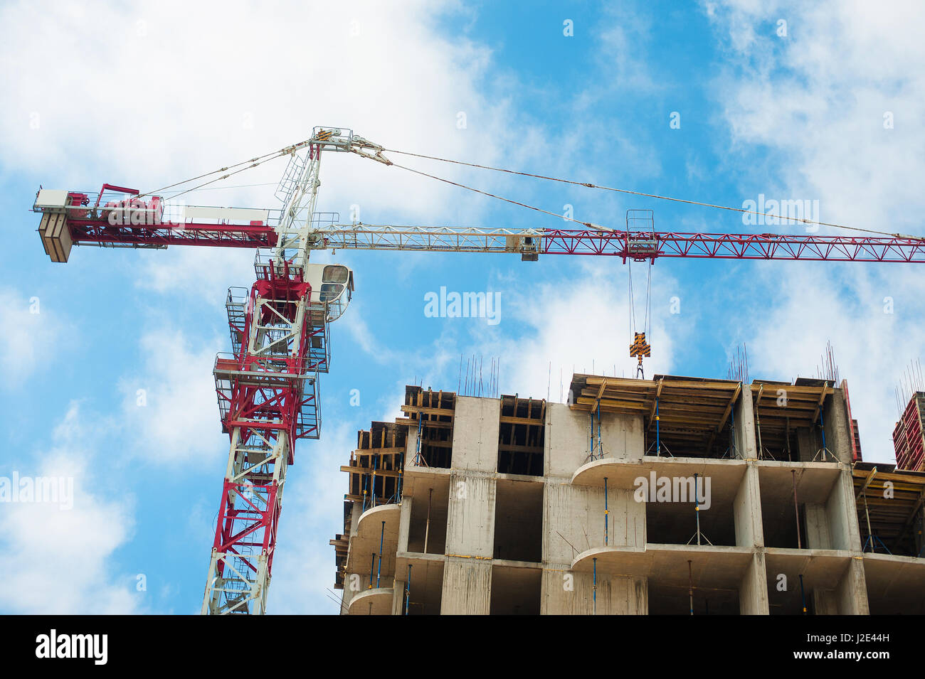 Hoisting crane and house construction. Construction of a skyscraper ...