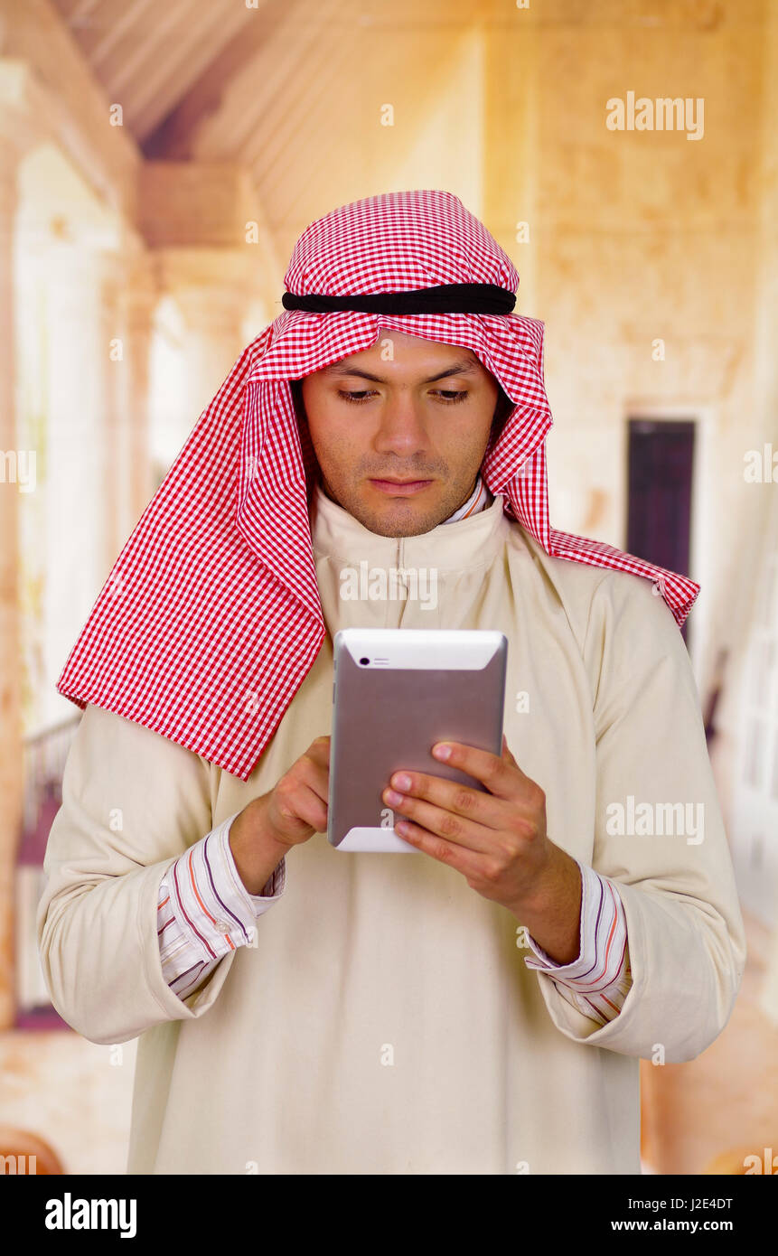 Cute young arabian man using his Tablet Stock Photo - Alamy
