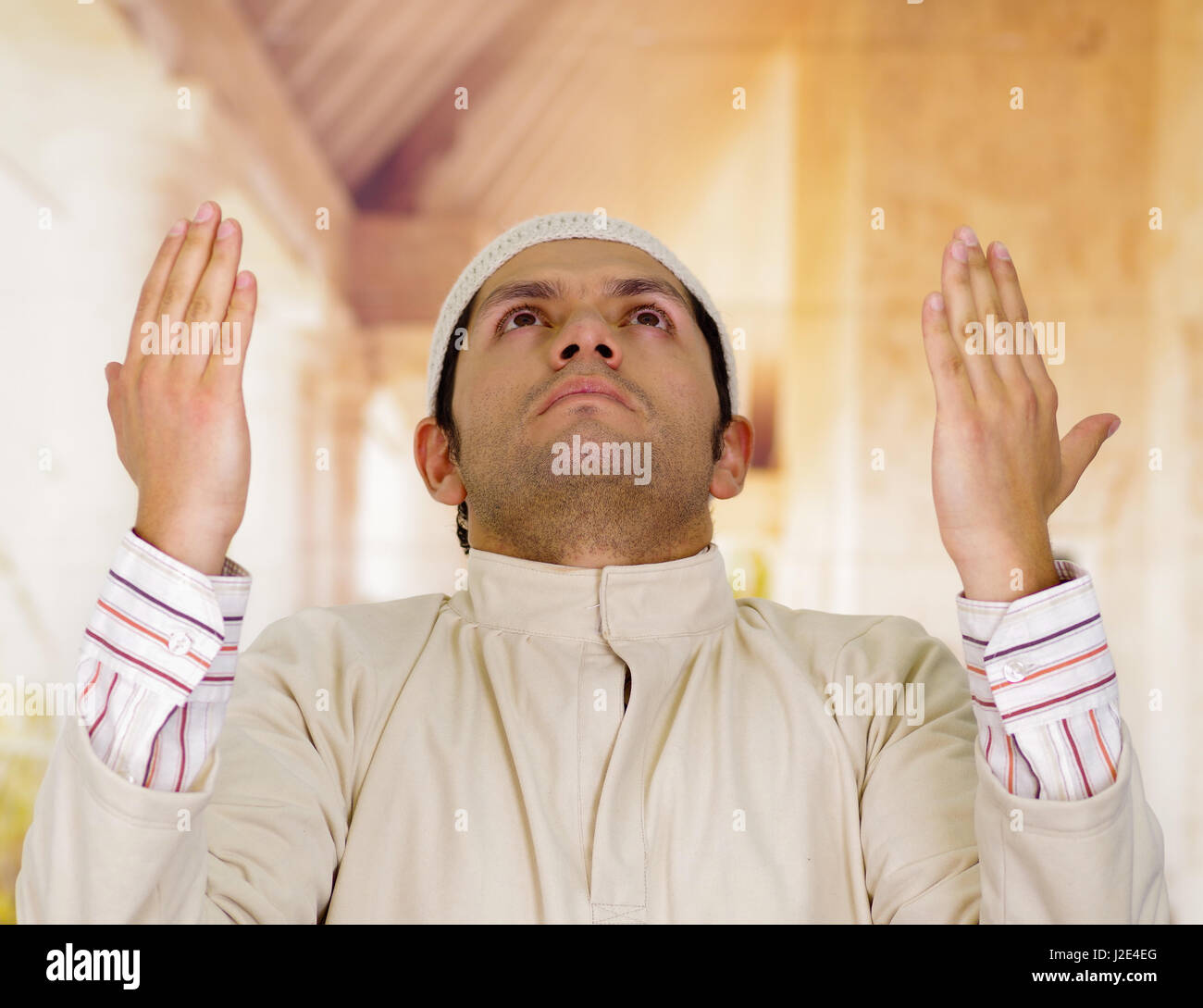 Cute young arabian guy praying to god Stock Photo - Alamy