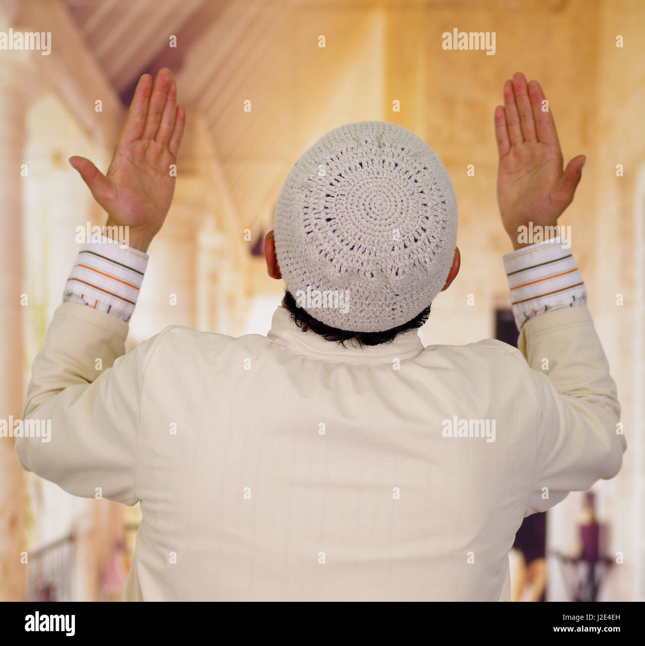 Cute young arabian guy praying to god Stock Photo - Alamy