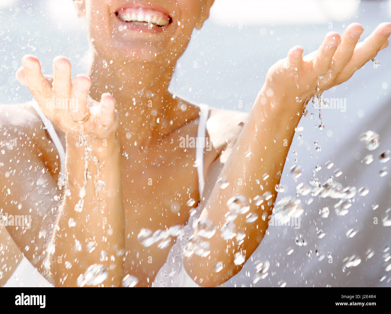 Young woman and water splash Stock Photo - Alamy
