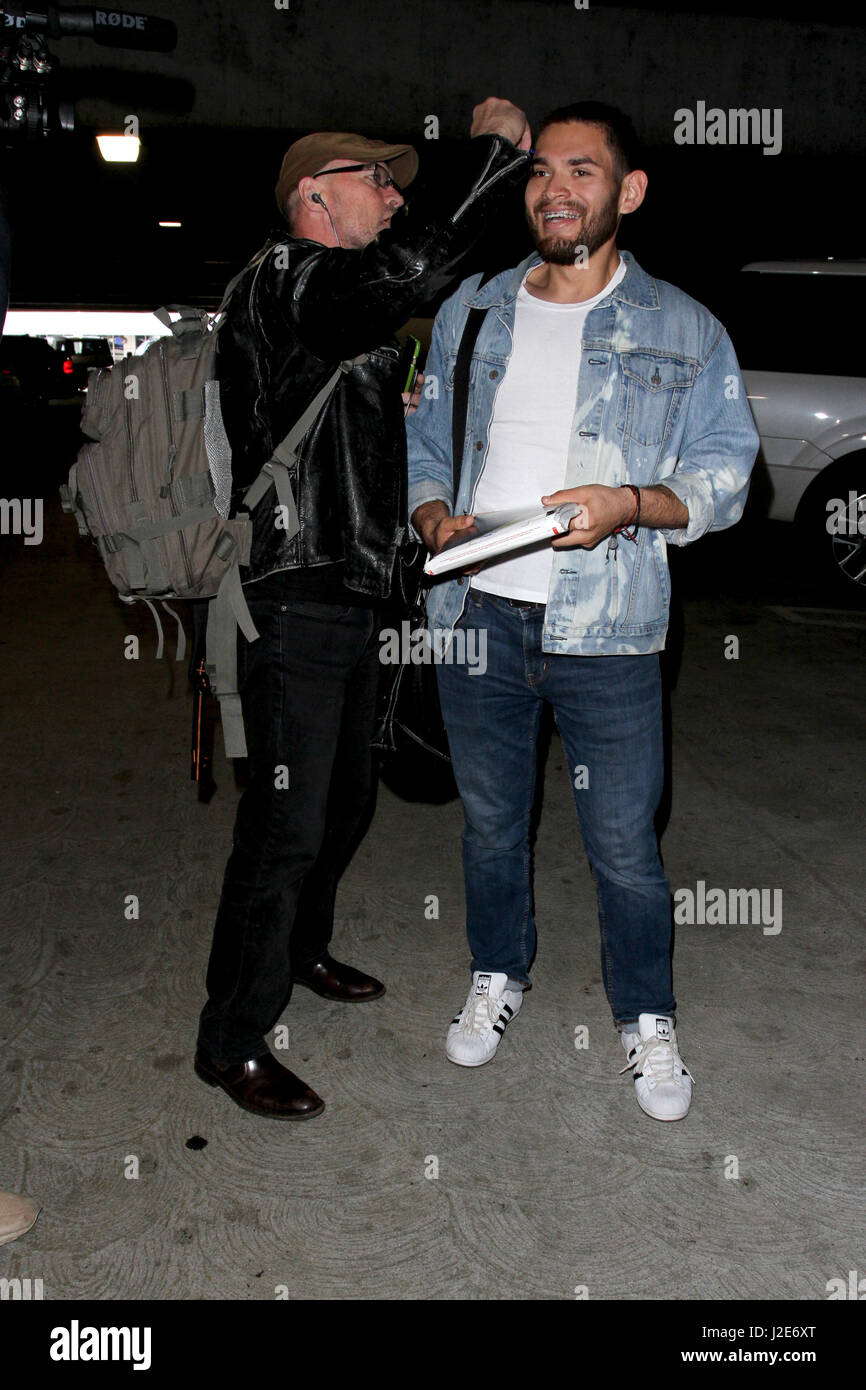 Michael Rooker signing a fan's head after arriving at Los Angeles ...