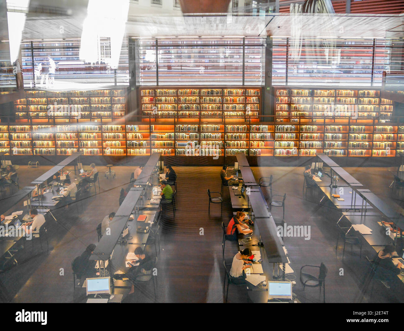 Students studying in Library with their computers and books Stock Photo ...