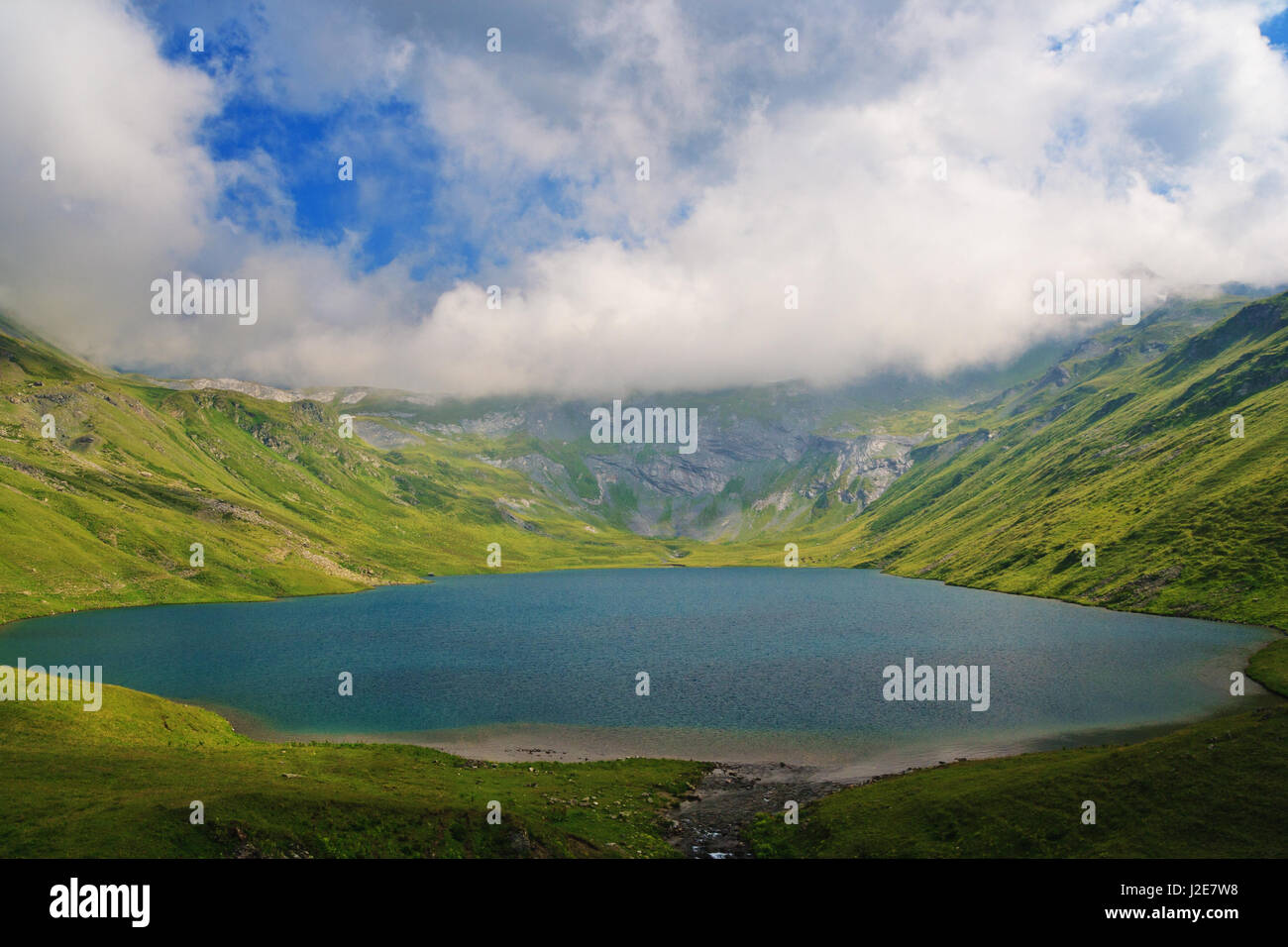 Mountain Lake in the mountains of Western Caucasus. Bright blue sky and ...
