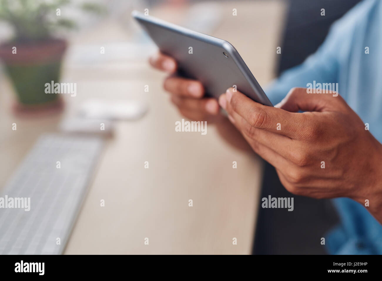 Designer using a tablet at his desk in an office Stock Photo - Alamy