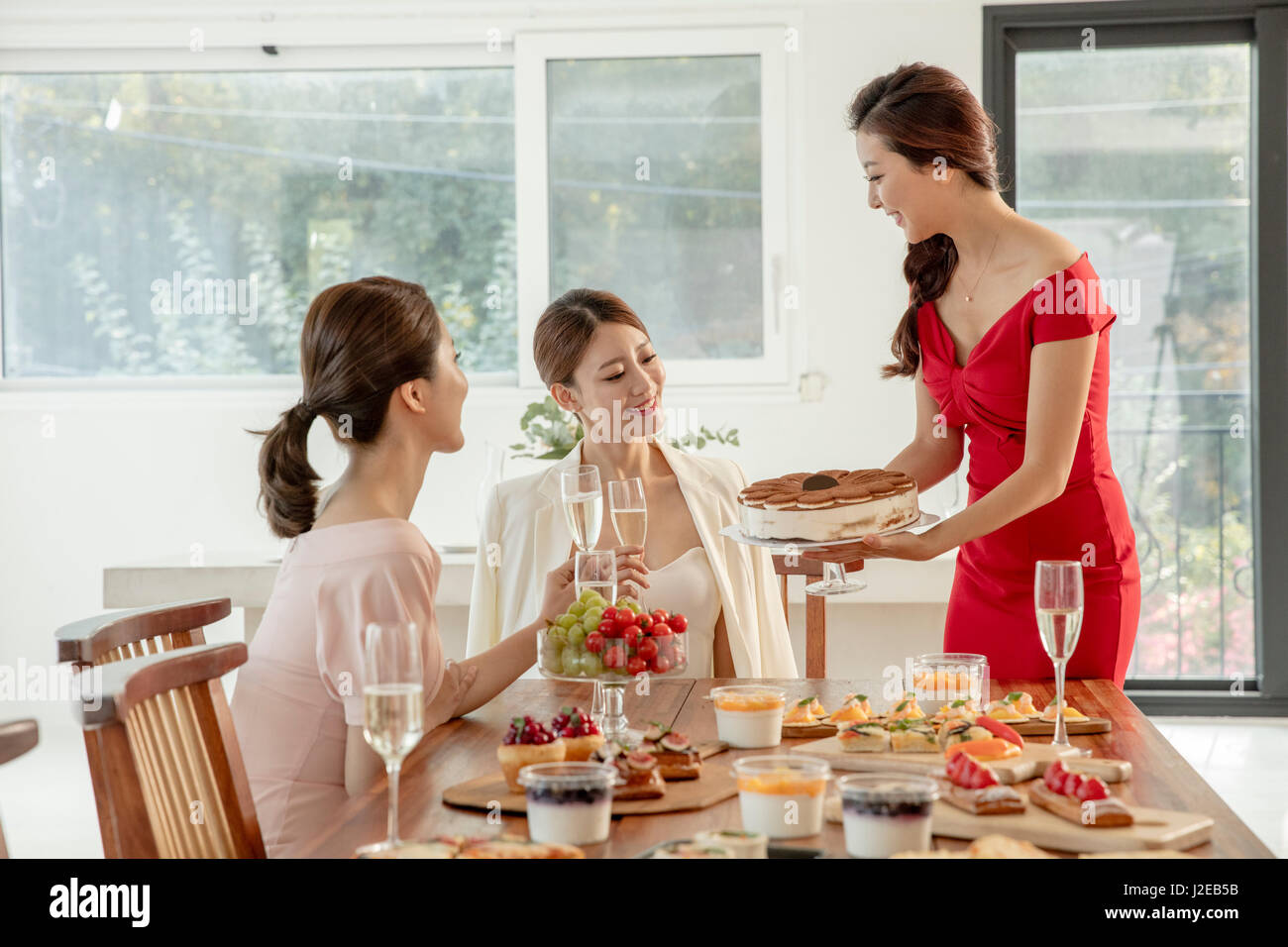 Three young smiling women at party Stock Photo - Alamy