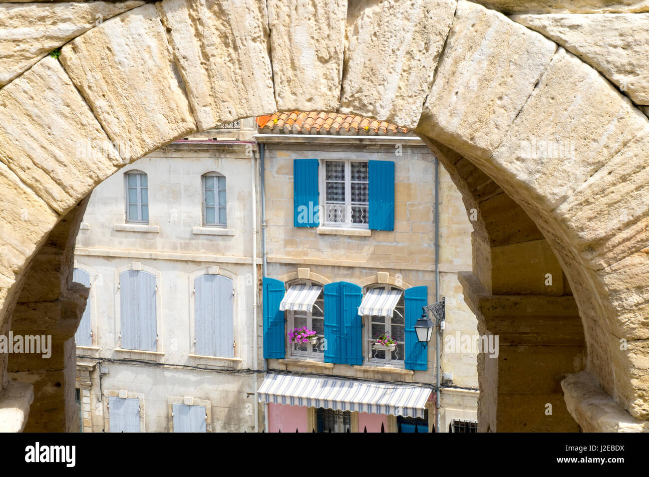 France, Arles, Roman Amphitheater arch and typical French window scene ...