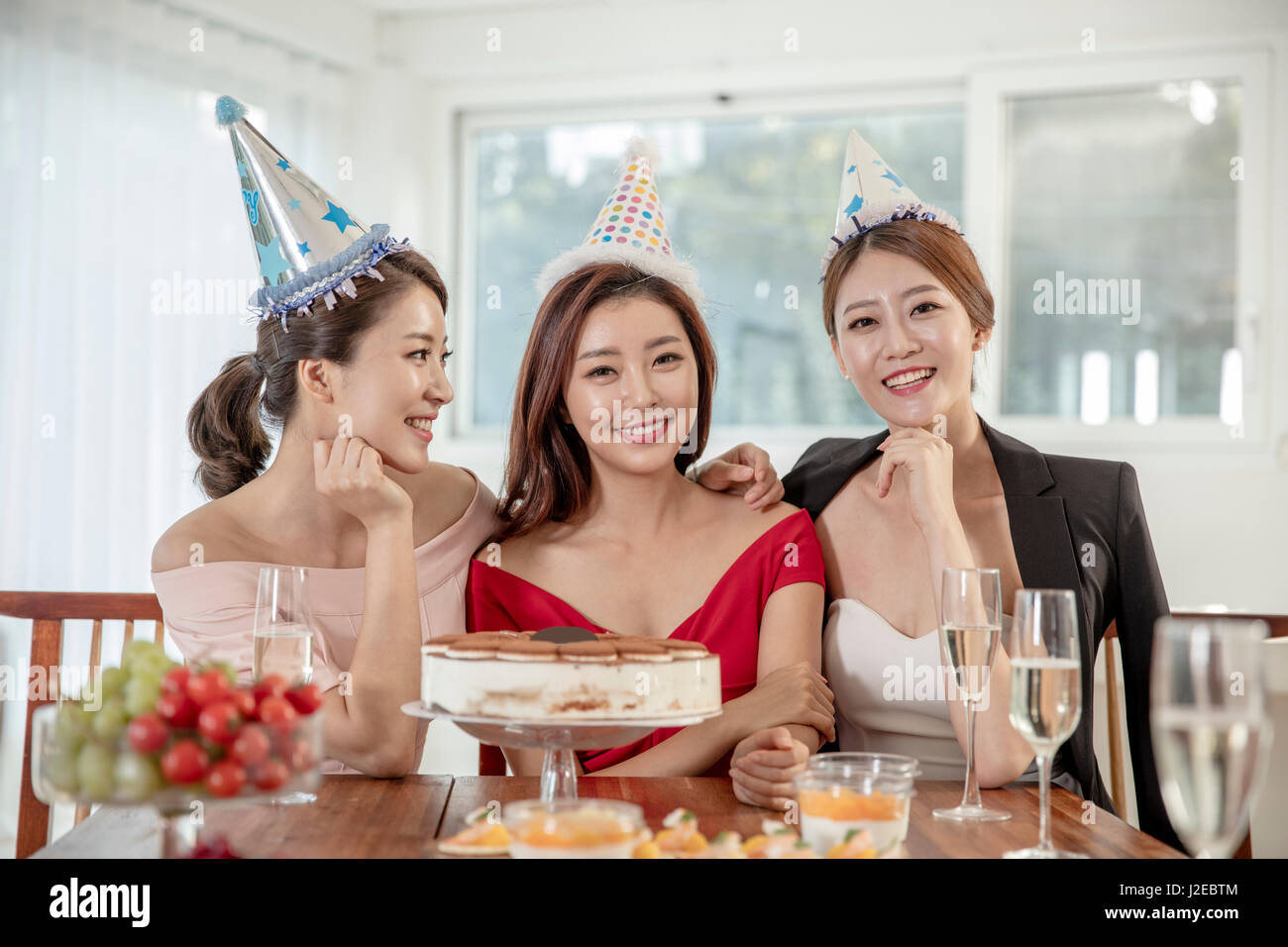 Three young smiling women at party Stock Photo - Alamy