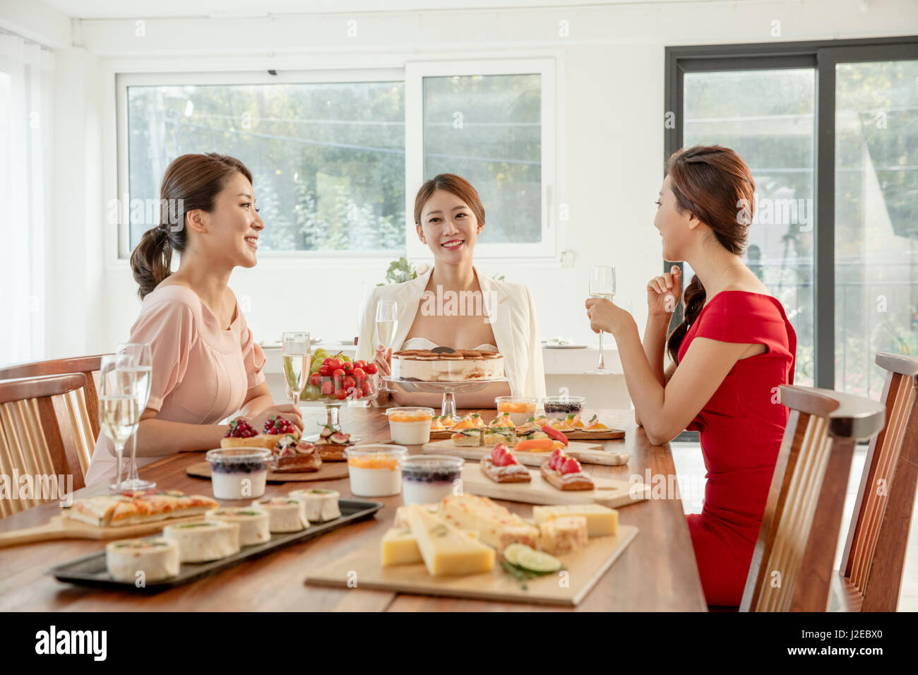 Three young smiling women at party Stock Photo - Alamy