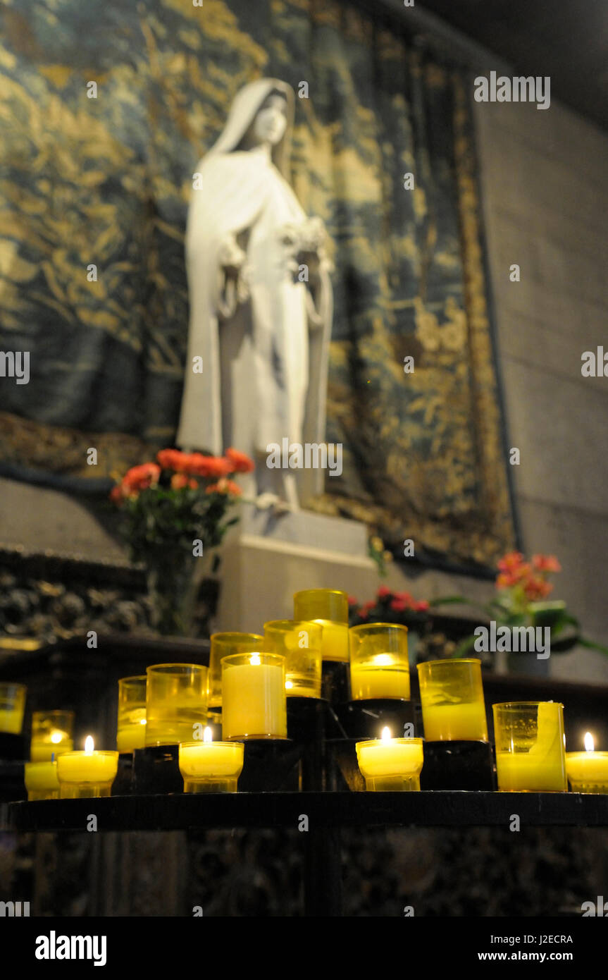 France, Rhone-Alpes, Lyon. Votive candles in front of sculpture ...