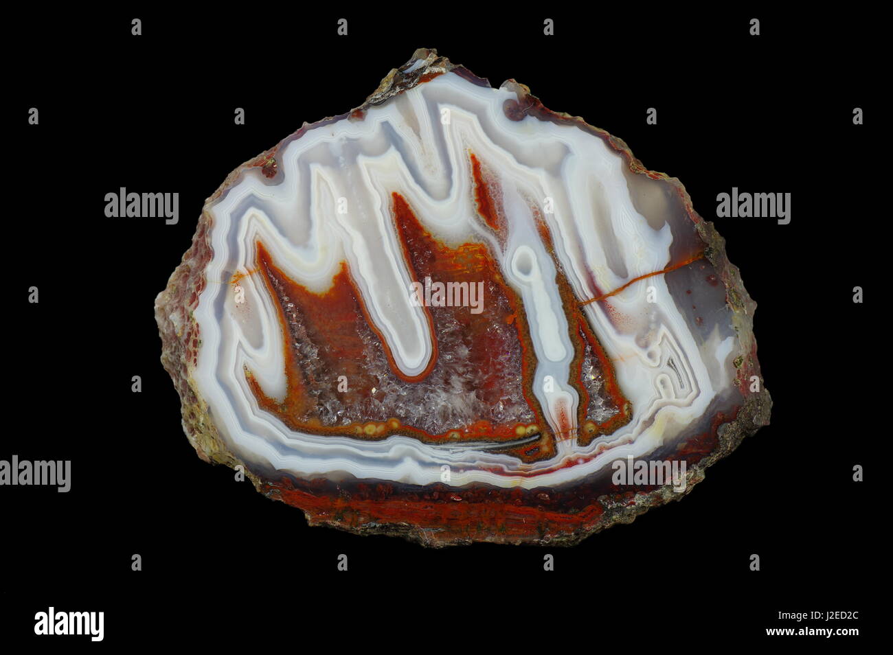 A cross section of the stalactite agate stone with quartz geode. Silica ...