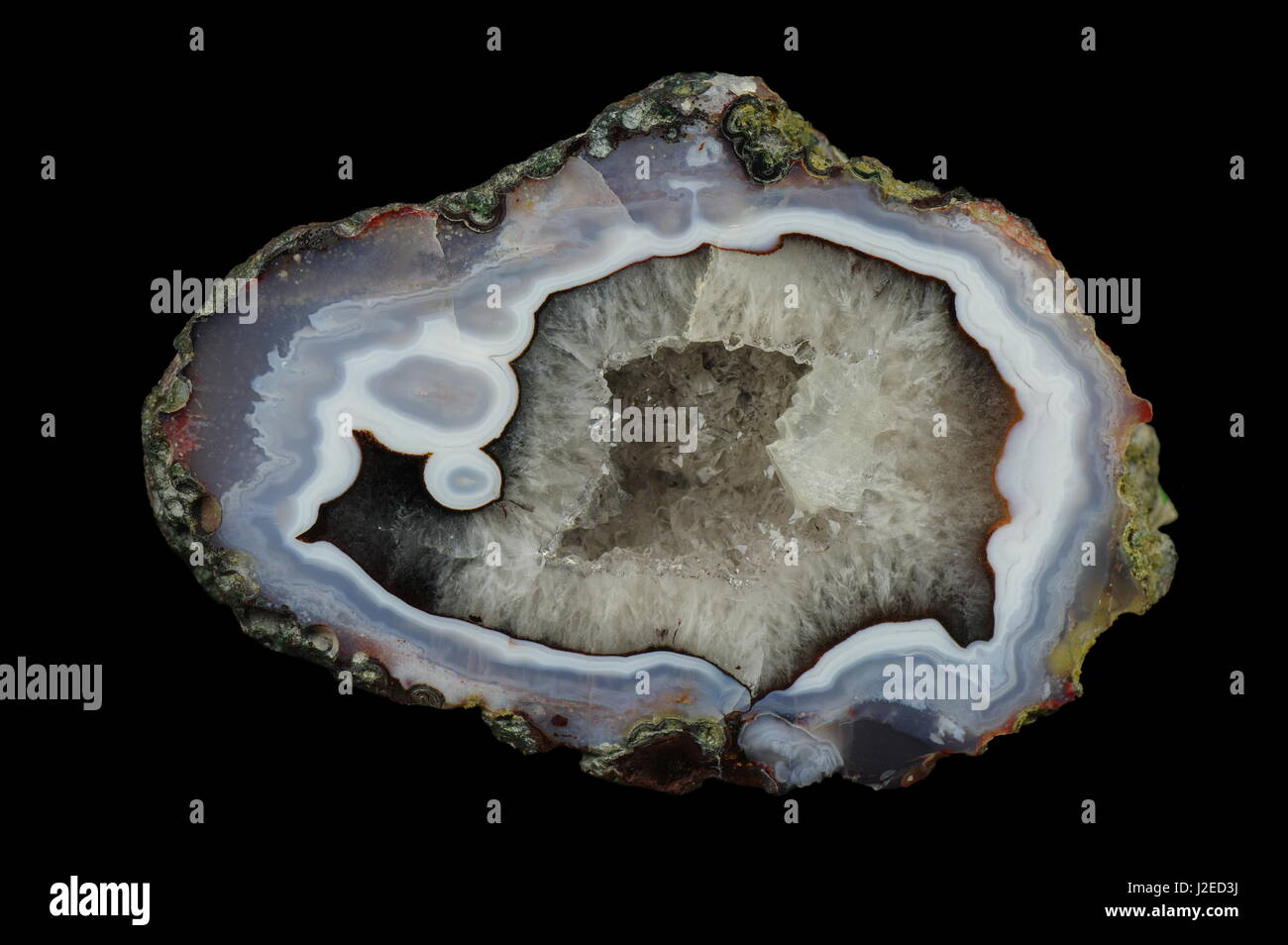 A cross section of the agate stone with quartz geode. Multicolored ...