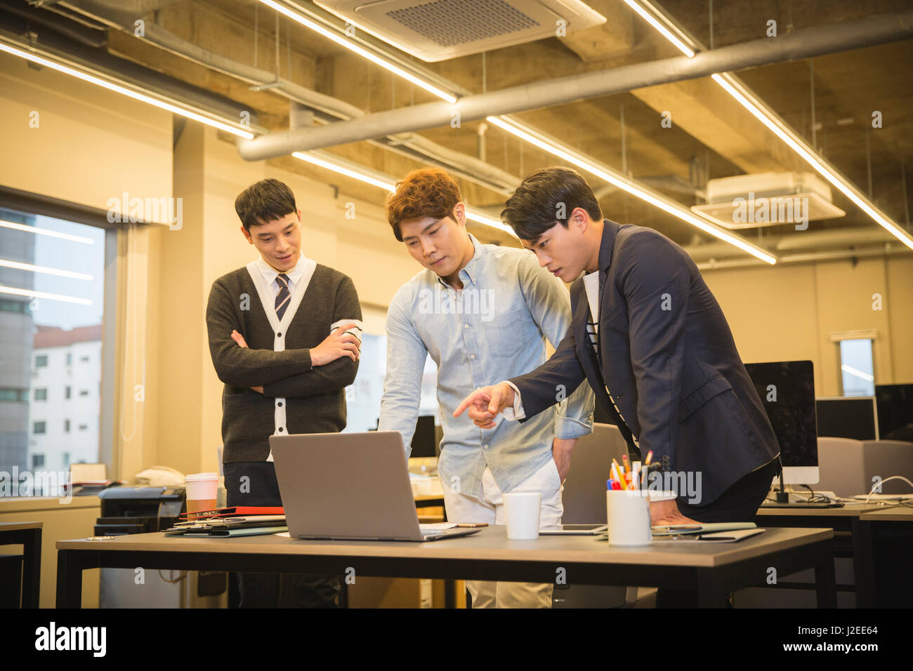 Three businessmen at work Stock Photo - Alamy