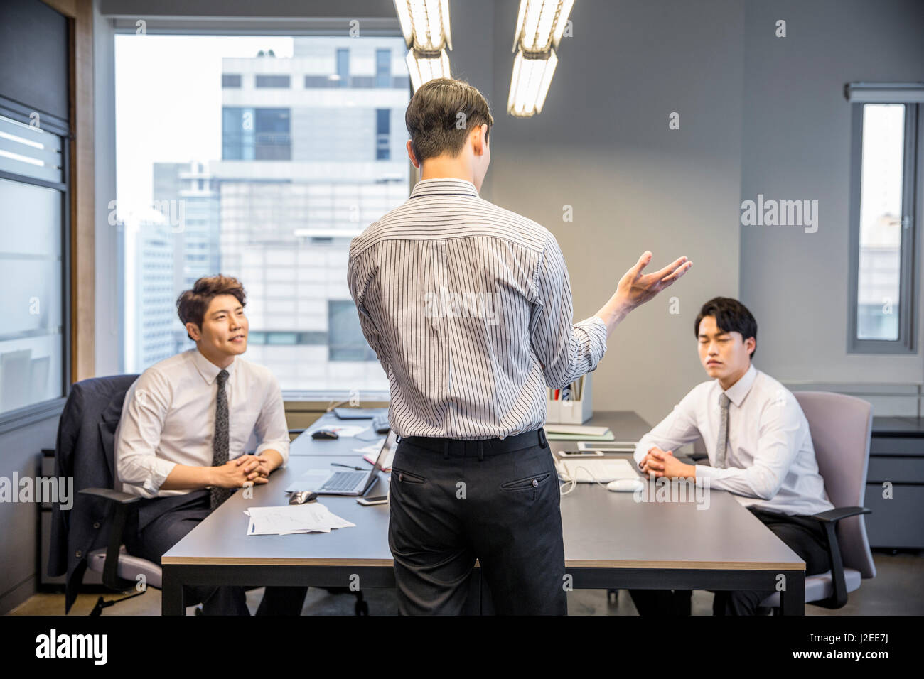 Three businessmen having a meeting Stock Photo - Alamy