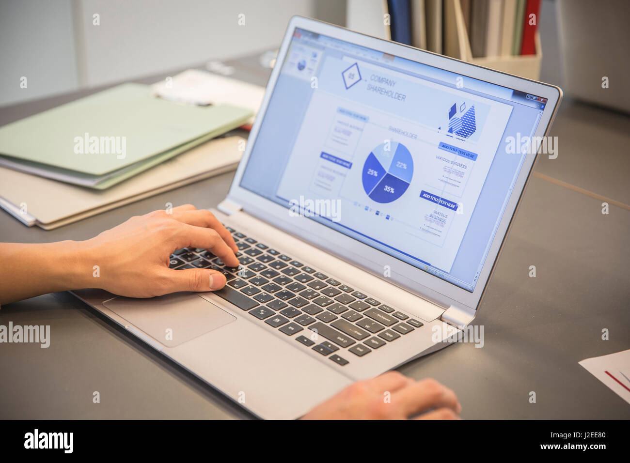 Hands using notebook computer at office Stock Photo - Alamy