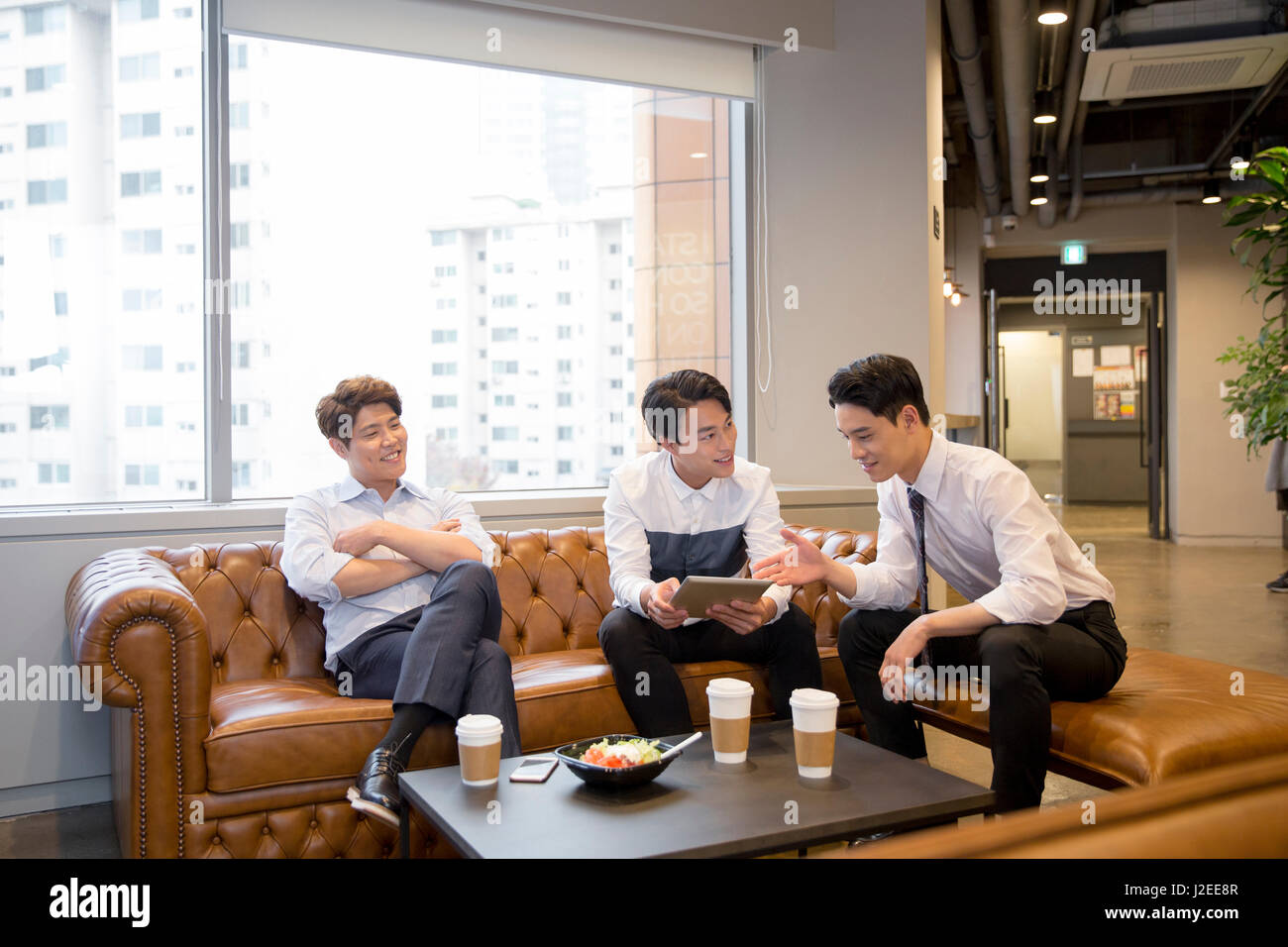 Three smiling businessmen Stock Photo - Alamy