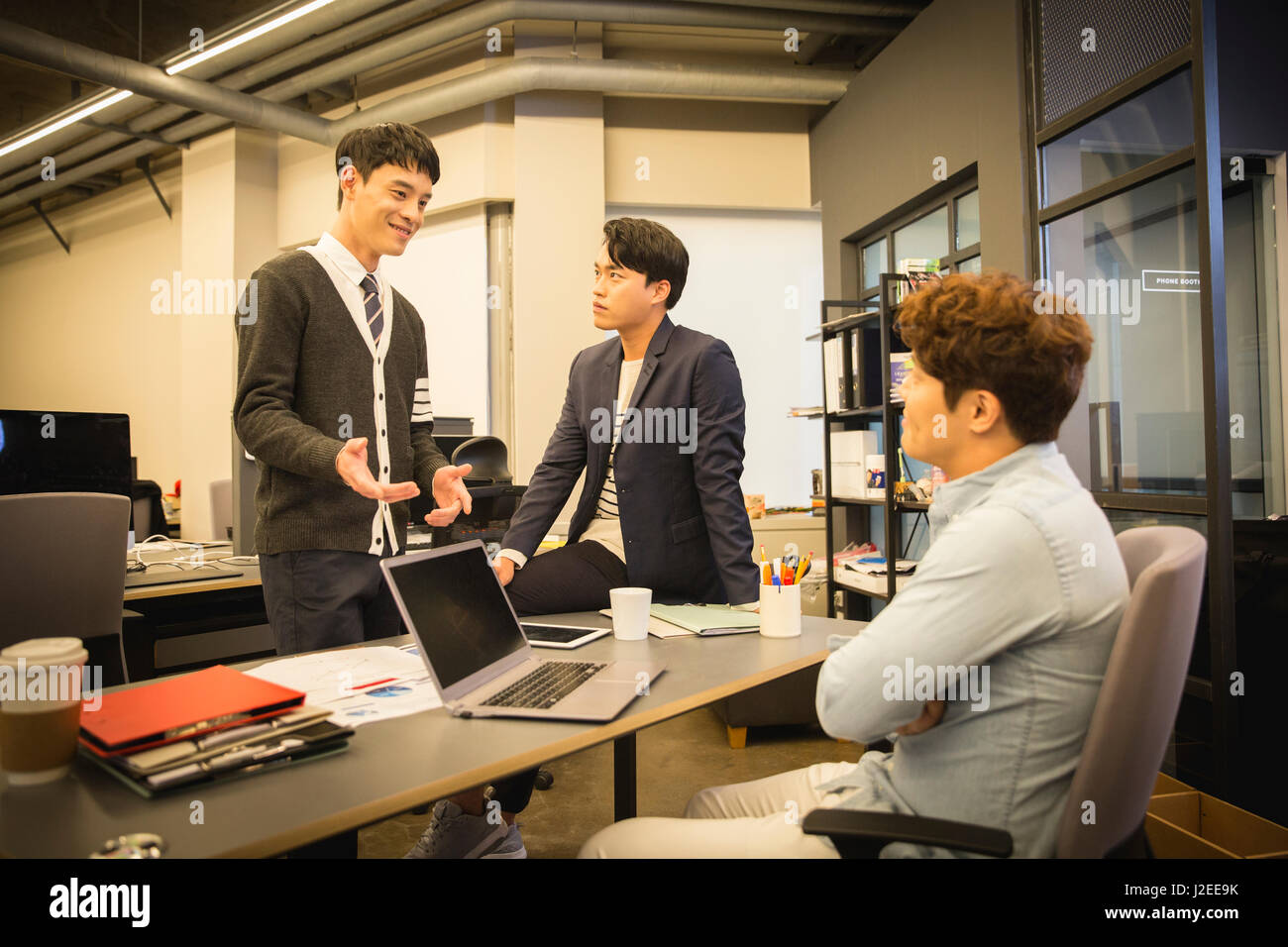 Three smiling businessmen at office Stock Photo - Alamy