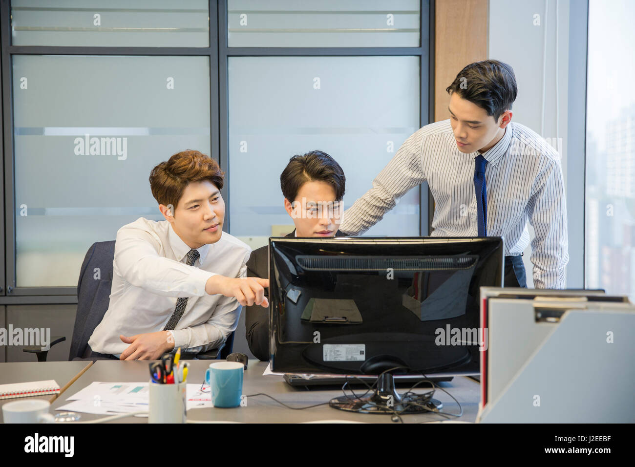Three businessmen at work Stock Photo - Alamy