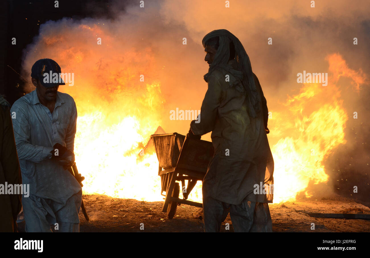 Lahore, Pakistan. 28th Apr, 2017. Pakistani laborers work by a smelter ...