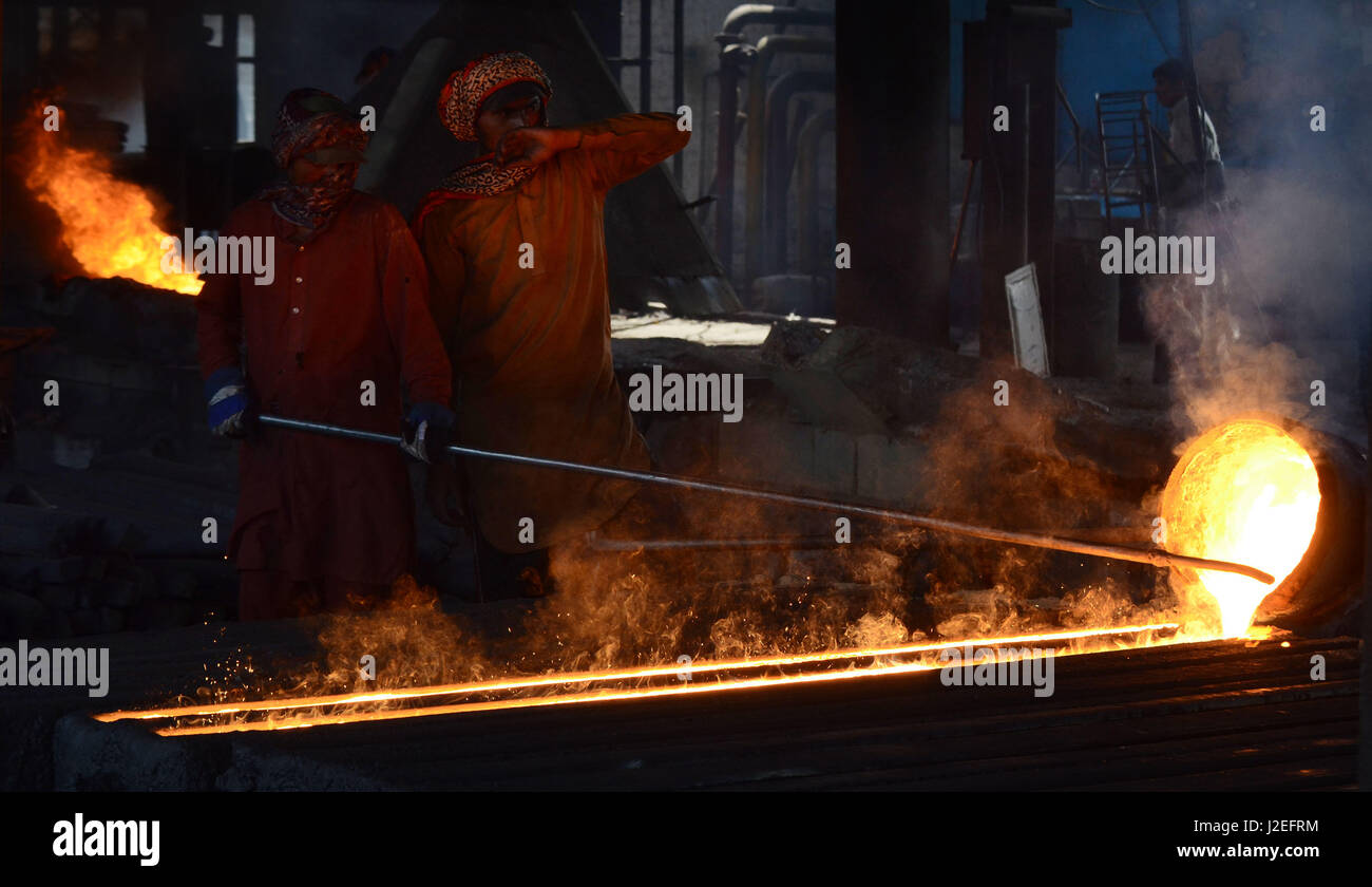 Lahore, Pakistan. 28th Apr, 2017. Pakistani laborers work by a smelter ...