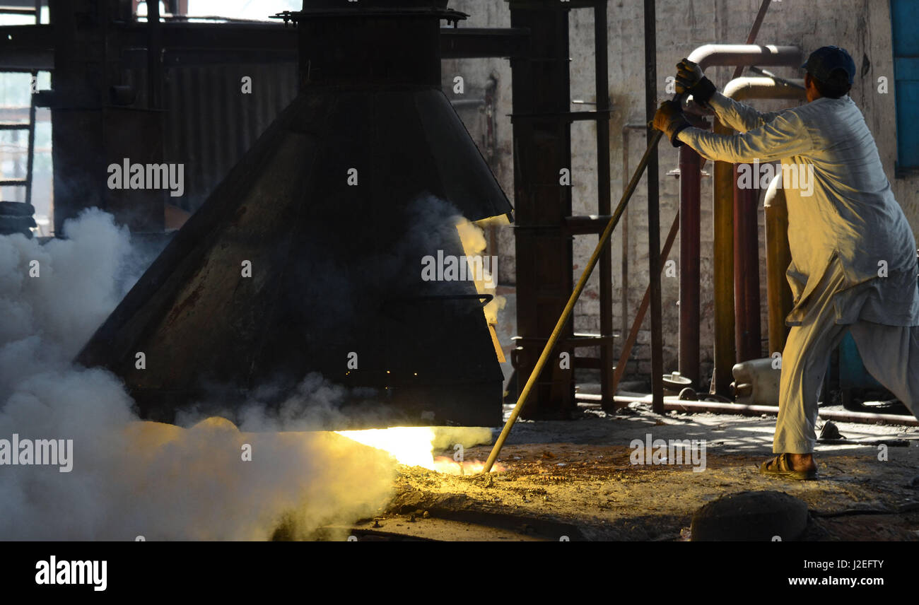 Lahore, Pakistan. 28th Apr, 2017. Pakistani laborers work by a smelter ...