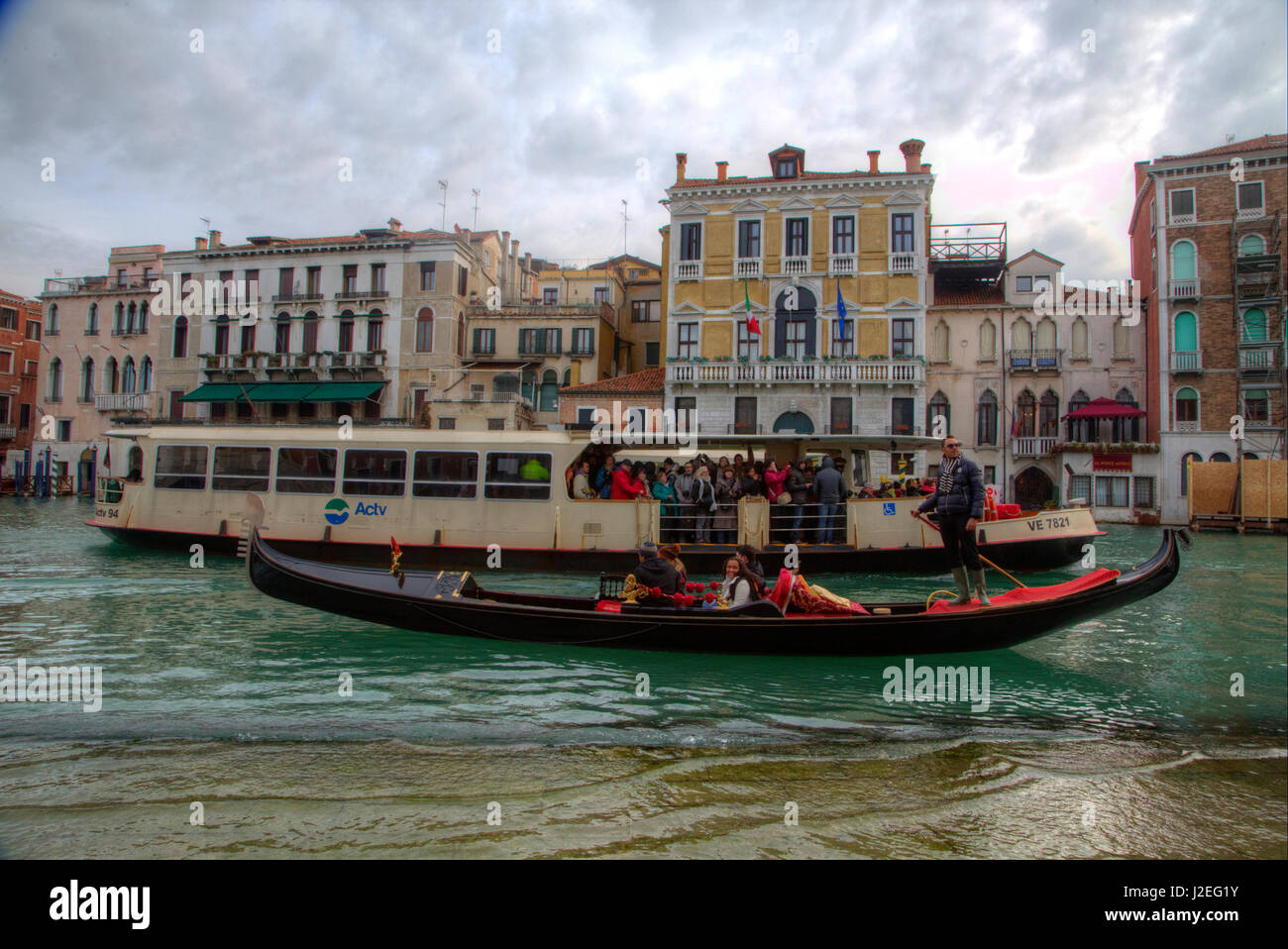 Gondola and Vaporetto, water bus, along the Grand canal of Venice ...
