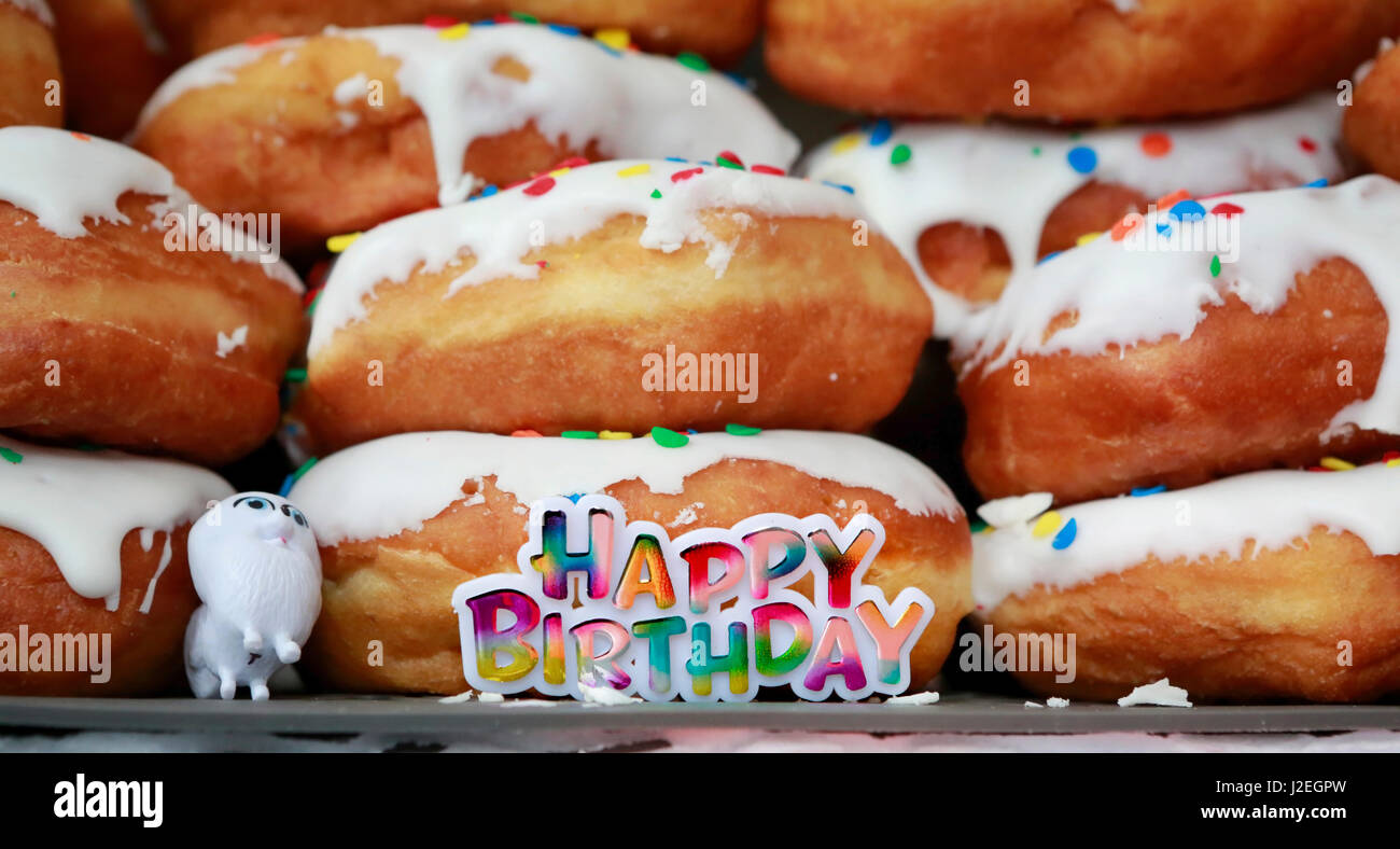 Colorful Happy Birthday sign on sweet donuts background Stock Photo - Alamy