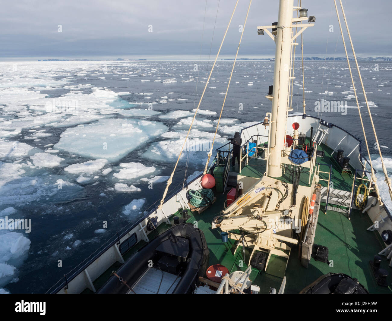 Arctic Ocean, Norway, Svalbard. Ship plows through drift ice. Credit as ...