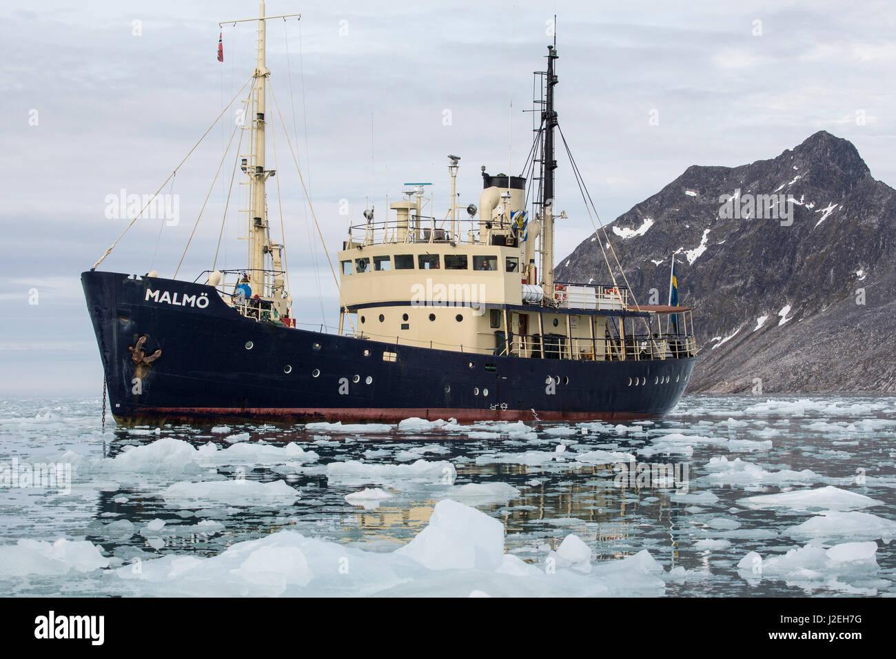 Arctic Ocean, Norway, Svalbard. Ship anchored in drift ice. Credit as ...