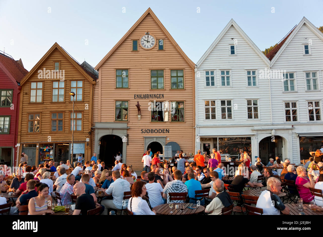 People sat at pavement bars, cafes, Bryggen, the medieval quarter of ...