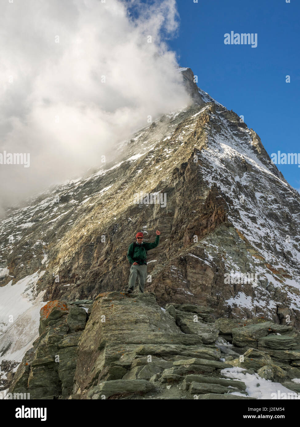 Switzerland, Zermatt, climber at base of original climbing route on ...