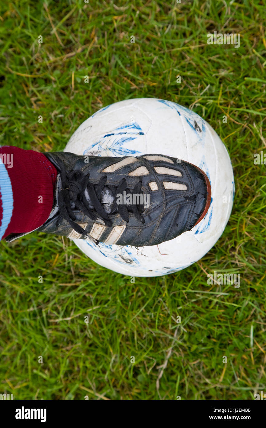 Under 8 football player, boot and ball Stock Photo - Alamy