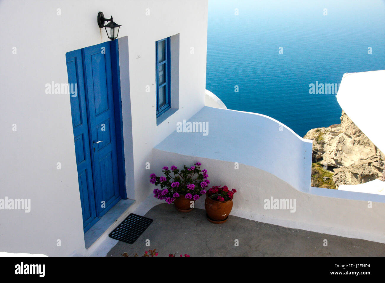 Santorini, Greece. Blue door, flower pots, white washed buildings, and ...