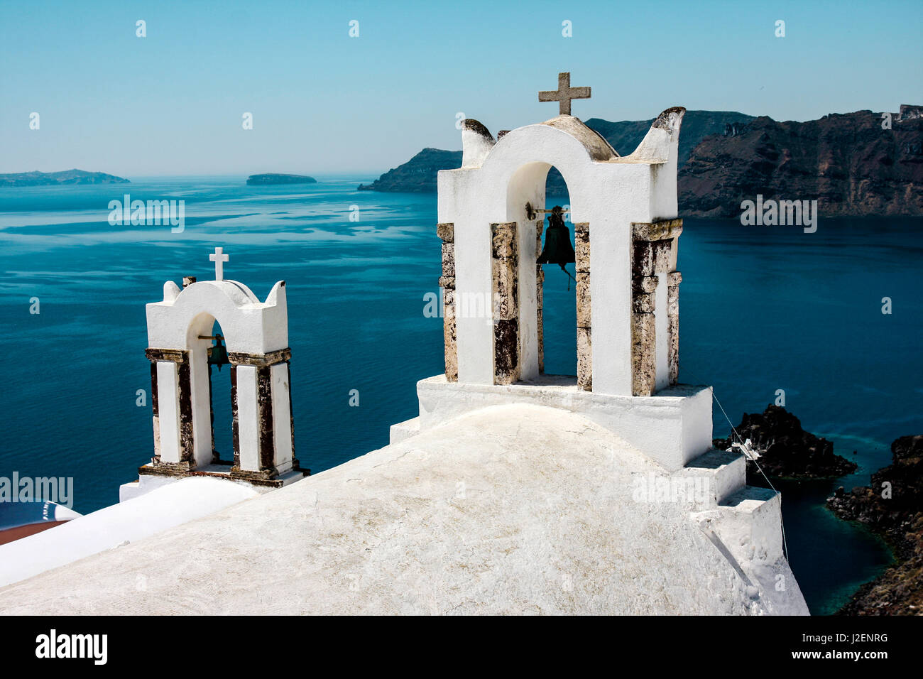 Oia, Santorini, Greece. Two Greek church bells overlook the Caldera and ...