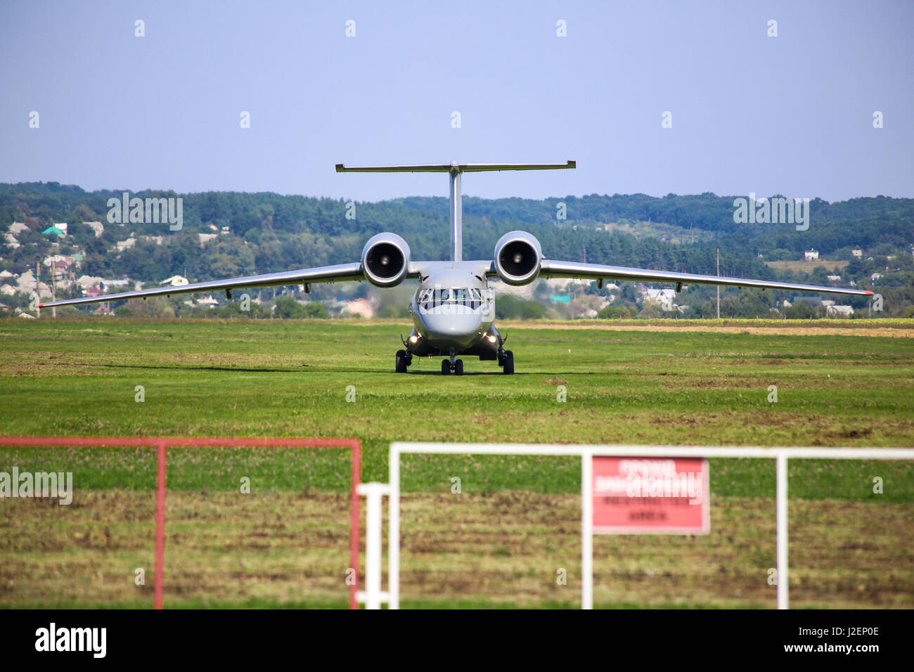 Light military-transport jet An-72 landing on grass airfield Stock ...