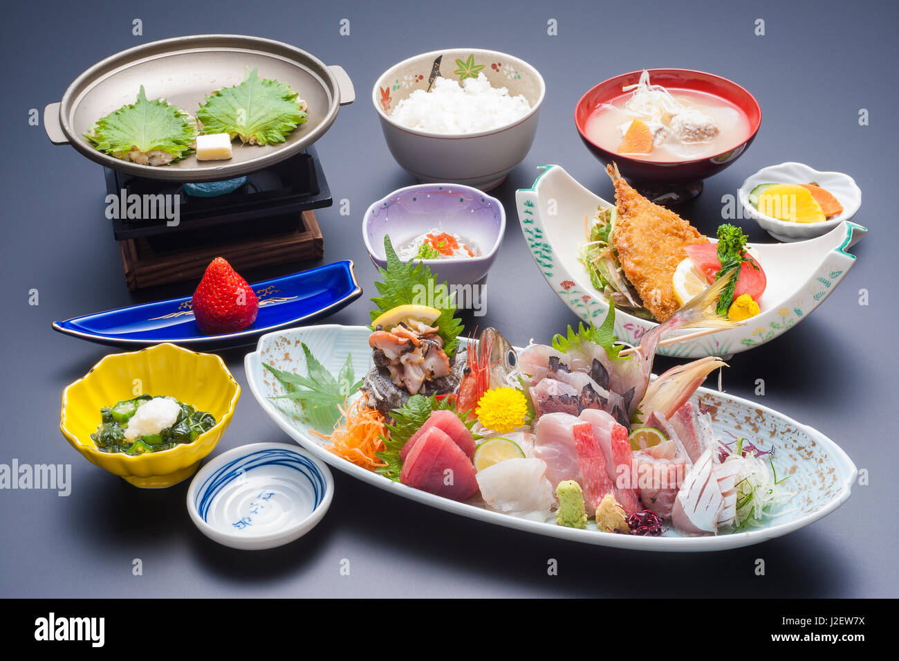 Japanese special meal with sushi tuna, shrimp, shell, fried fish, and ...